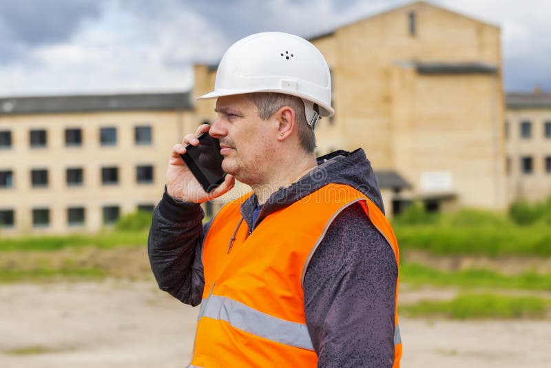 Engineer Talking on Cell Phone Near Building Stock Image - Image of ...