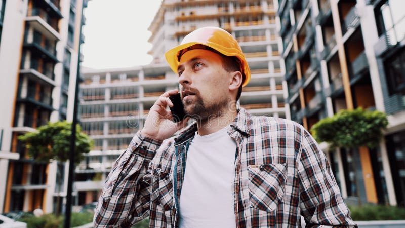 Engineer Talking on Phone. Architect Using Phone on Construction Site ...