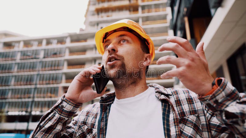 Engineer Talking on Phone. Architect Using Phone on Construction Site ...