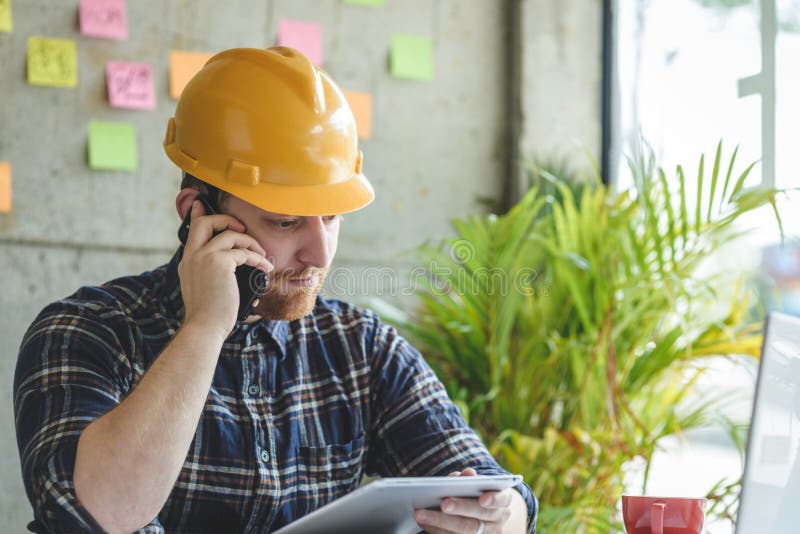 Engineer Talking with Phone and Looking at Tablet Stock Photo - Image ...