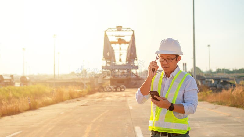 Engineer Talking on Walkie-talkie and Using Smart Phone for Working at ...