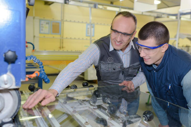 Engineer Teaching Apprentice To Use Grinding Machine Stock Photo ...