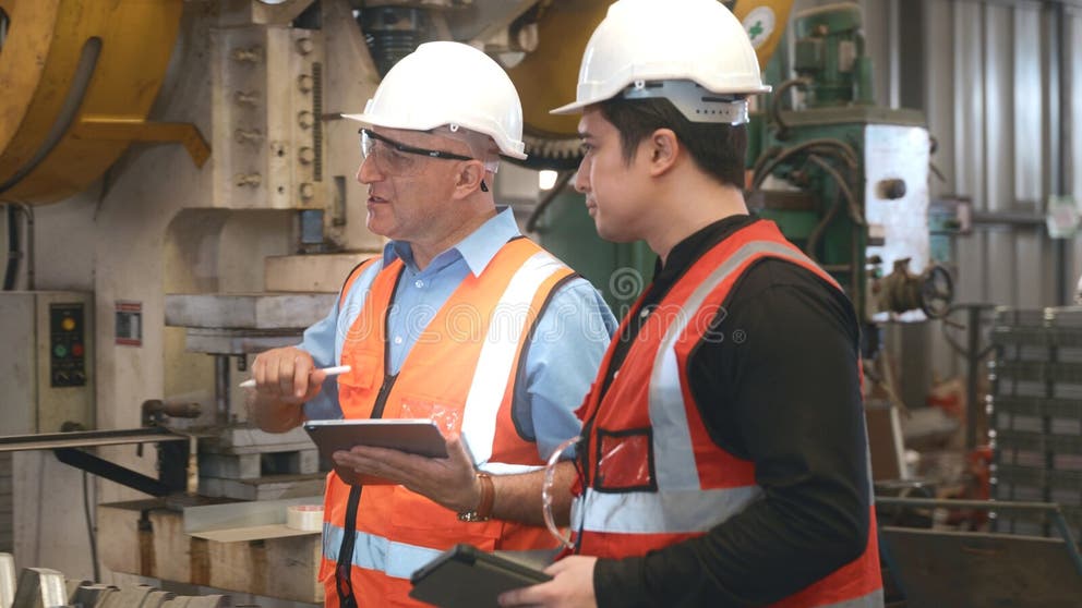 Engineer Teaching Apprentice To Use Metal Sheet Stamping Machine Stock ...