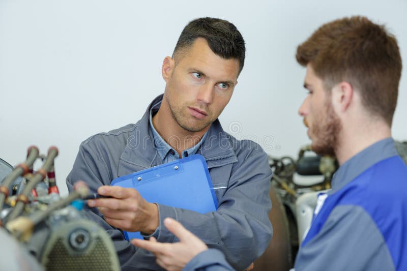 Engineer Teaching Apprentices To Use Computerized Metal Processing ...