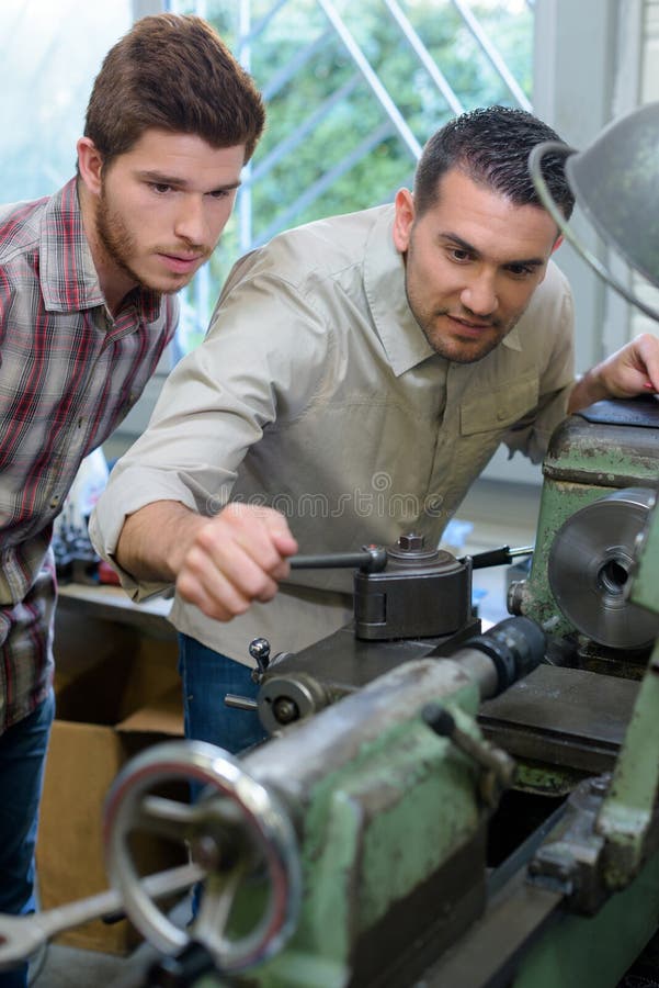 Engineer Teaching Apprentices To Use Metal Processing Machines Stock ...