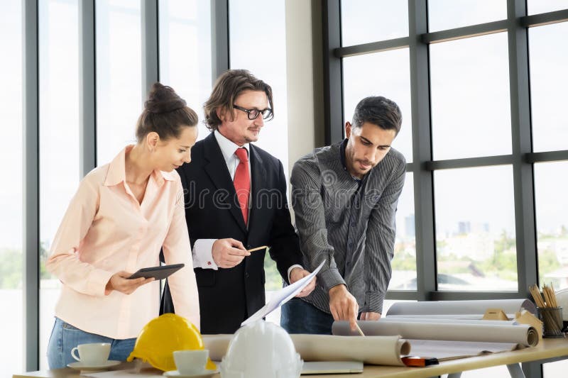 Engineer Team Meeting To Inspect the Construction Blueprint Drawings ...