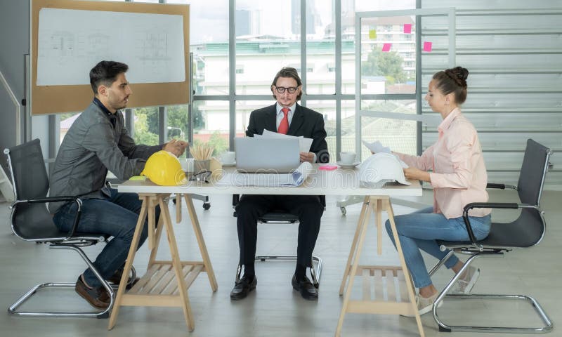 Engineer Team Meeting To Inspect the Construction Blueprint Drawings ...