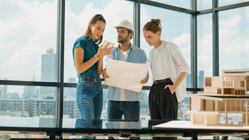 Engineer Team Talk about Design while Manager Hold at Project Plan ...