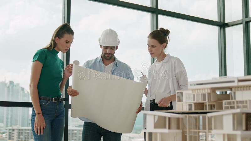 Engineer Team Talking while Look at Skyscraper and Reading at Plan ...