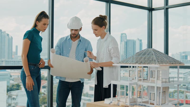 Engineer Team Talking while Look at Skyscraper and Reading at Plan ...