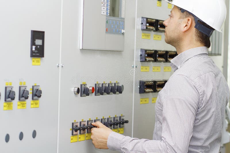 Engineer of Tech Equipment Controls. Worker in White Helmet on Control ...