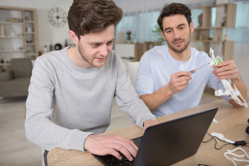 Engineer and Technician Working Together on Drone in Office Stock Image ...