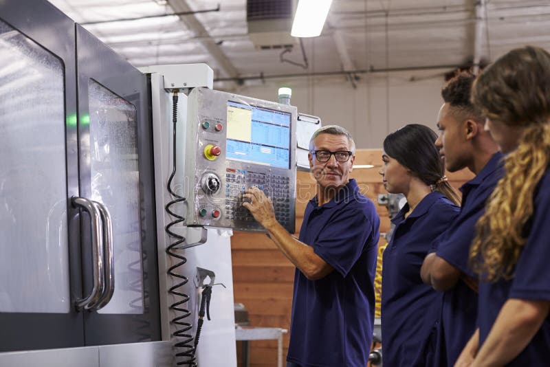 Engineer Training Apprentices on CNC Machine Stock Photo - Image of ...