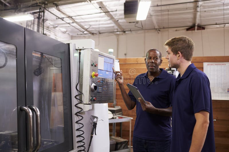 Engineer Training Male Apprentice on CNC Machine Stock Photo - Image of ...