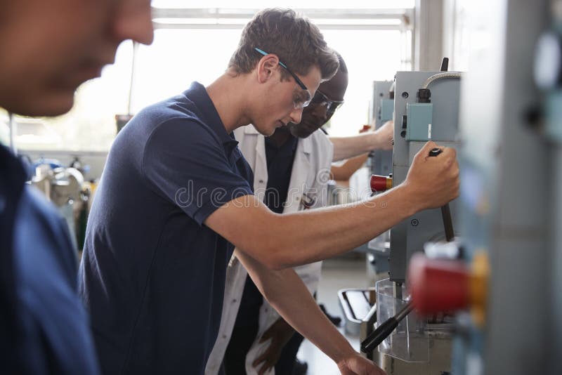 Engineer Training Male Apprentice Using a Drill Press Stock Photo ...