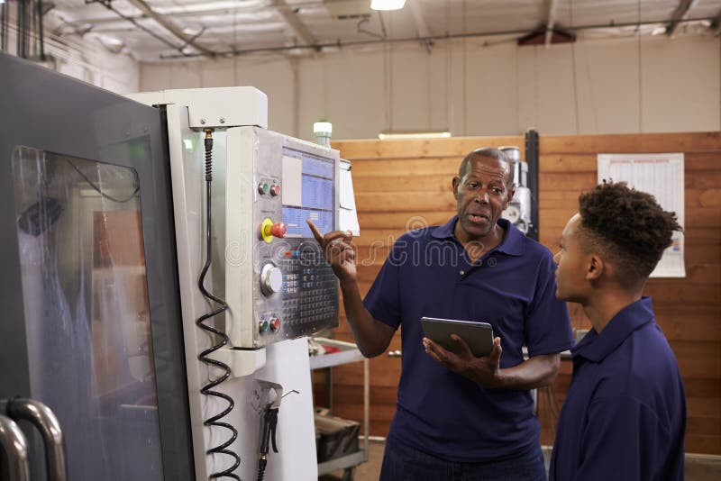 Engineer Training Young Male Apprentice on CNC Machine Stock Image ...