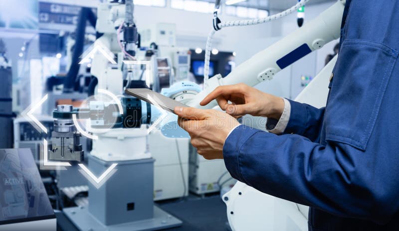 Engineer Uses A Digital Tablet To Control Robots In A Smart Factory