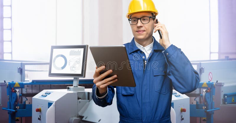 Engineer Uses A Digital Tablet To Control Robots In A Smart Factory