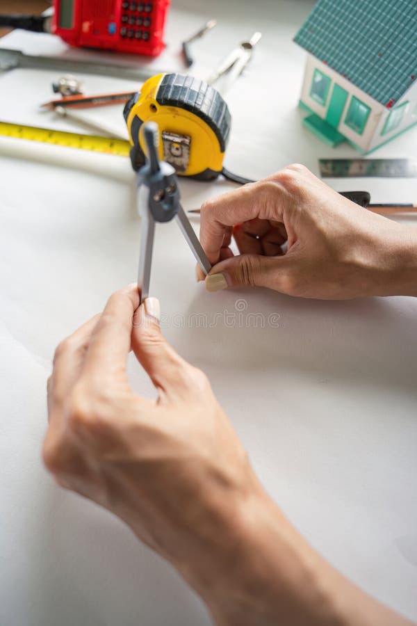 Engineer Using Compass for Precise Measurements in Office Stock Image ...