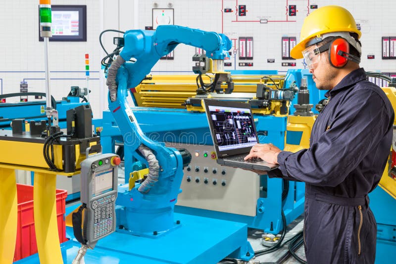 Engineer Using Laptop Computer for Control Automatic Robotic Stock ...
