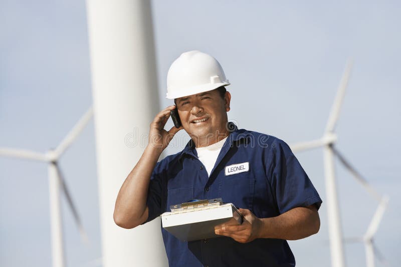 Engineer Using Mobile Phone at Wind Farm Stock Image - Image of ...
