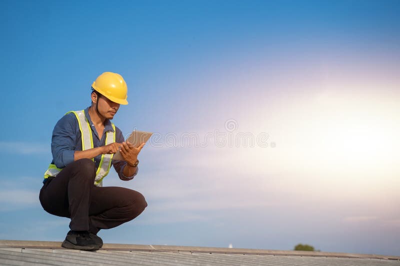 Engineer Using Tablet To Inspect Work at Job Site. Concept of ...