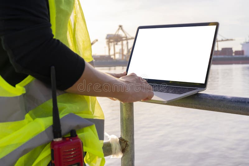 An Engineer is Using a Tablet To Work, she is at the Shipping Dock ...