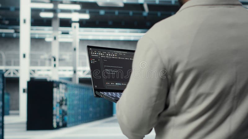 Engineer Walking in Data Center Using Device To Configure Hardware ...