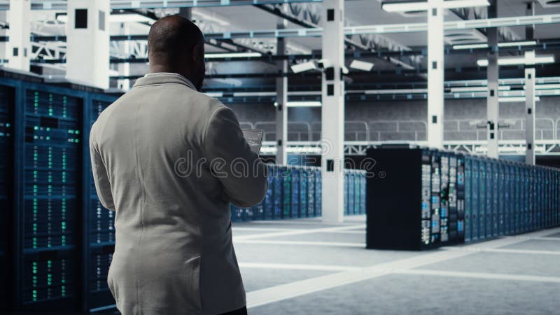 Engineer Walking in Server Farm, Automating System Diagnostics Stock ...