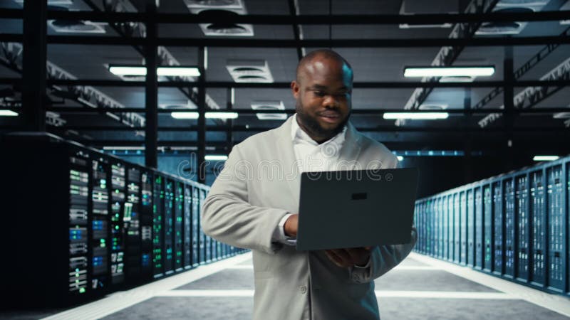 Engineer Walking in Server Room Backing Up Storage Arrays Using Software Stock Footage - Video ...
