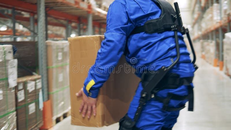 Engineer Wearing Exoskeleton, Exosuit. Warehouse Worker in Ergoskeleton ...
