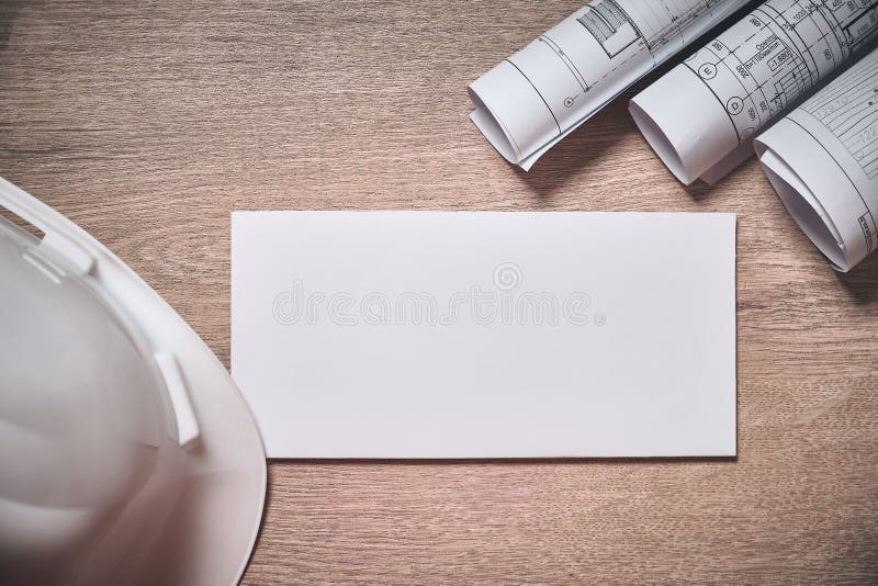 Engineer Hardhat, Rolled Drawings and Blank White Envelope at Wooden ...