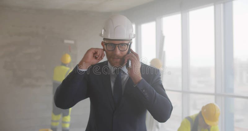 Engineer in White Helmet Calling on Smartphone at Construction Site ...