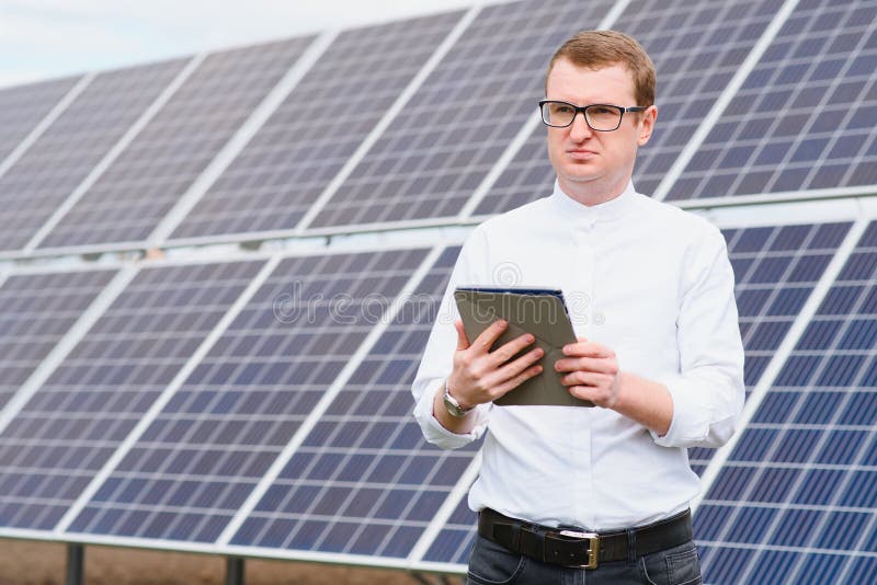 Engineer in a White Helmet. Man Near Solar Panel Stock Image - Image of ...