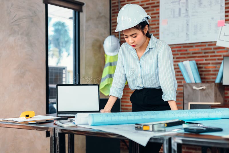 Engineer Woman Read Drawing Blue Print on Table Workplace at Room Site ...
