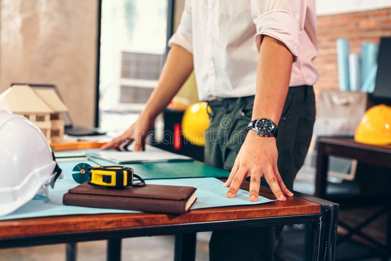 Engineer Woman Read Drawing Blue Print on Table Workplace at Room Site ...