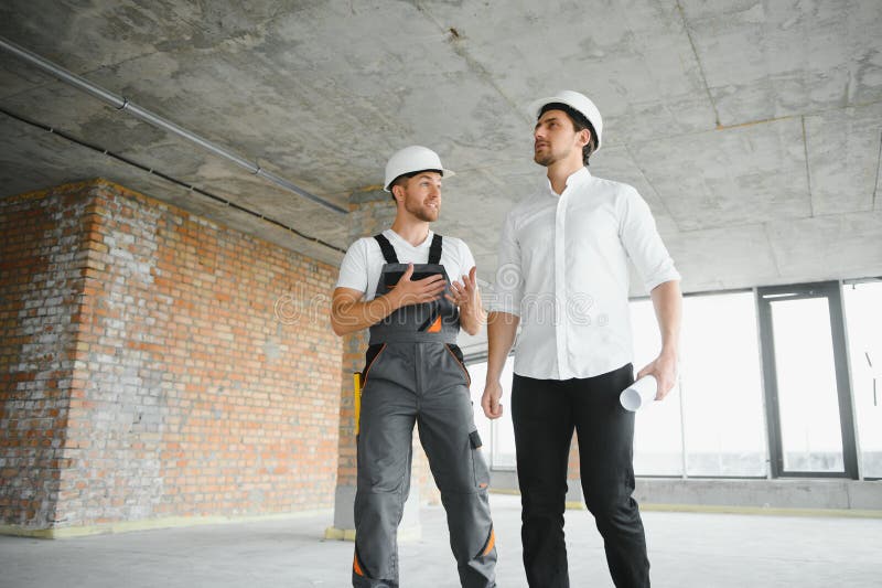 Engineer and Worker Checking Project at Building Site Background ...