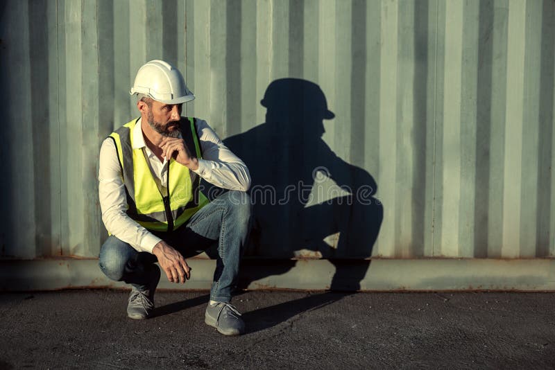 Engineer or Worker Sit Close To Cargo Container Look Like Tired and ...