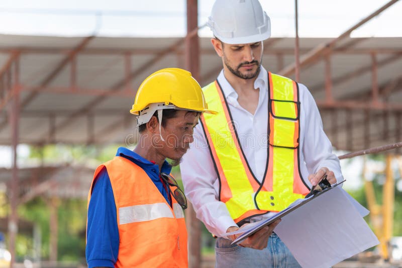 Engineer and Worker Team Meeting for Planning Project at Construction ...