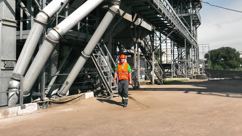 Engineer Worker Walking by Industrial Tubing at a Plant, Engineer ...