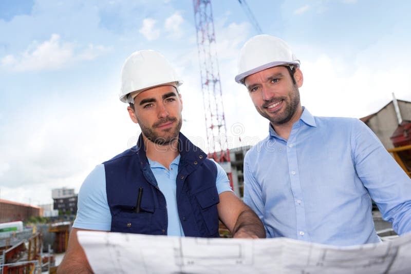 Engineer and Worker Watching Blueprint on Construction Site Stock Image ...