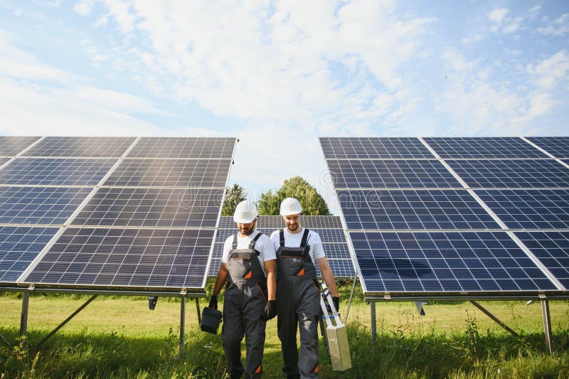 Engineer Worker Working in Solar Panels Power Farm. Two Technician ...