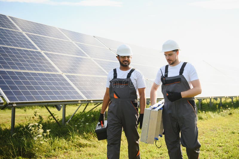 Engineer Worker Working in Solar Panels Power Farm. Two Technician ...