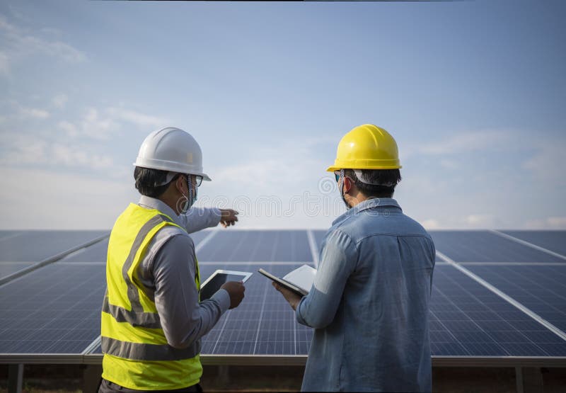 Engineer and Worker Working Together in the Solar Panel Power Station ...