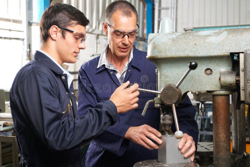 Engineer Working with Apprentice Using Drill Stock Image - Image of ...