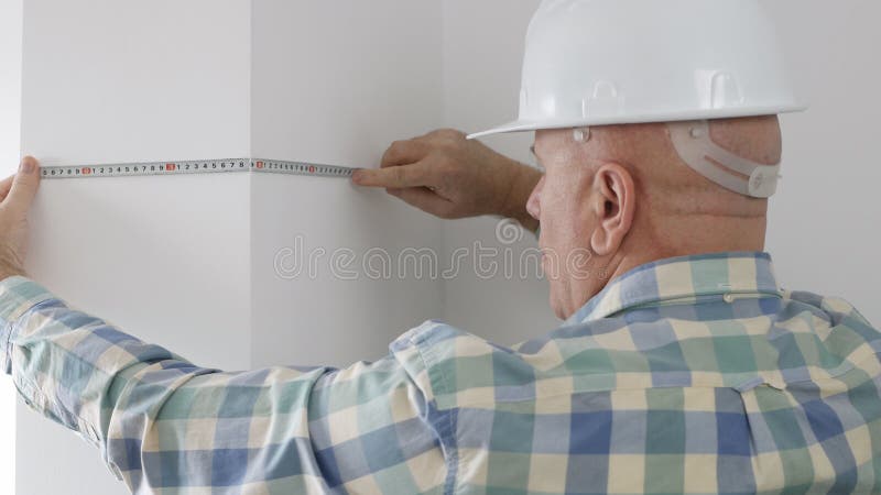 Engineer Working in a Construction Site Use a Tape Measure and Check ...