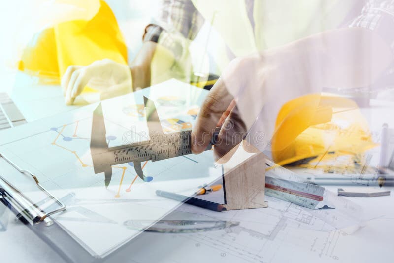 Engineer Working at a Drawings of House in Office for Discussing ...