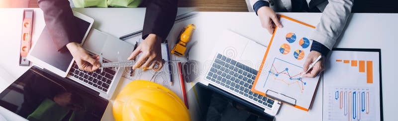 Engineer Working at a Drawings of House in Office for Discussing ...