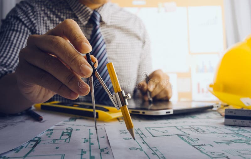 Engineer Working at a Drawings of House in Office for Discussing ...