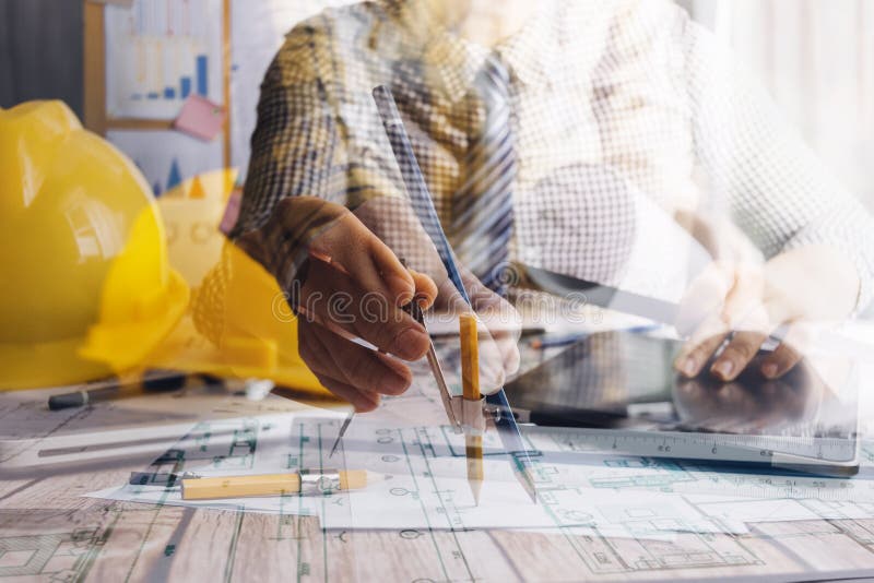 Engineer Working at a Drawings of House in Office for Discussing ...